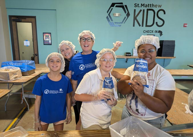 Volunteers in Rocklin pack meals for children at St Matthew